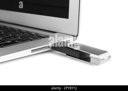 Modern usb flash drive attached into laptop on white background ...