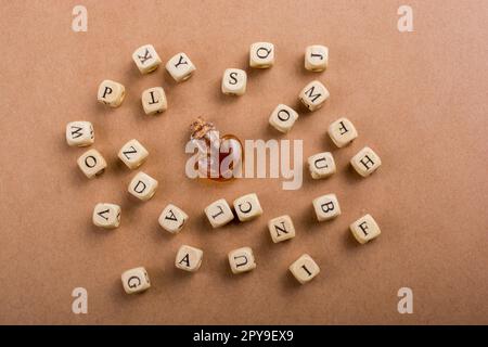 Wooden Letter cubes around love shaped bottle Stock Photo - Alamy