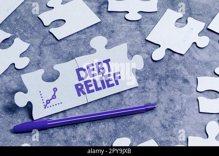 Hand writing sign Debt Relief. Business overview partial or total ...