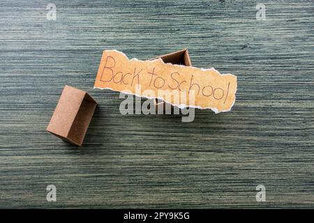 Back to school wording on a piece of torn paper Stock Photo - Alamy