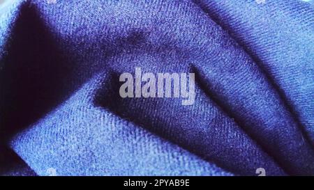 Dark blue fabric that looks like velvet or velveteen. Broken blue waves ...