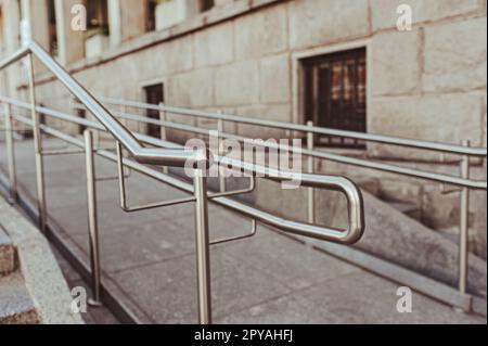 Tiled ramp with shiny metal railings outdoors Stock Photo - Alamy