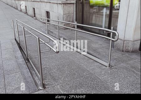 Tiled ramp with shiny metal railings outdoors Stock Photo - Alamy