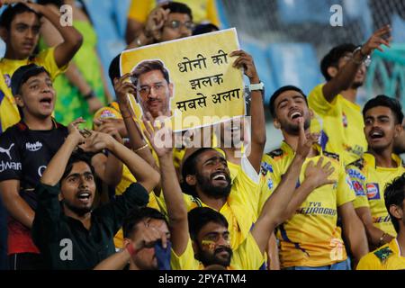 Fans of Chennai Super Kings' captain MS Dhoni hold a placard carrying his portrait during their ...
