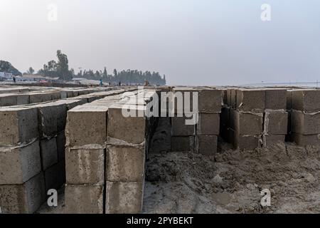 A pile of concrete blocks or boulders are isolated by the river to ...
