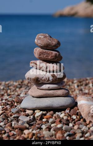 Close-up pyramid stones balance on the beach. Calm. Zen-like concept ...