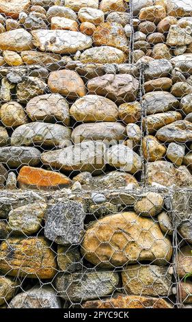 Stones rocks pinned behind a net in Zicatela Puerto Escondido Oaxaca ...