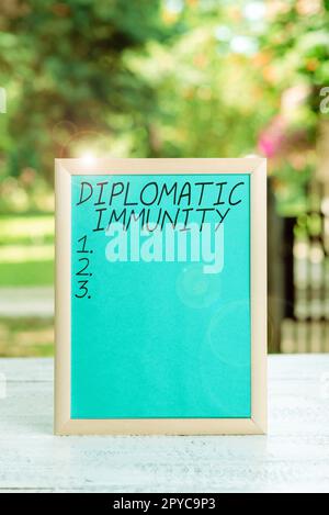 Sign displaying Diplomatic Immunity. Concept meaning law that gives ...