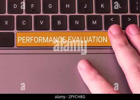 Sign displaying Performance Evaluation. Word Written on the development ...
