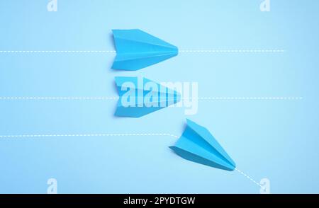 Three paper airplanes are moving forward, one turned sideways ...