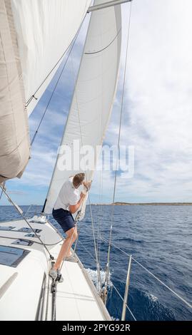 Man setting sail on his boat Stock Photo - Alamy