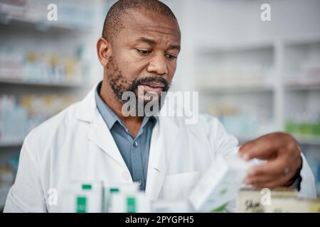 Pharmacist checking boxes of medicine Stock Photo - Alamy