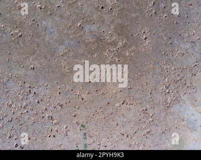 Concrete wall with concentric damage of large radius. Potholes ...