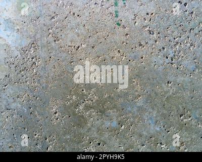 Concrete wall with concentric damage of large radius. Potholes ...