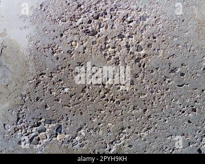 Concrete wall with concentric damage of large radius. Potholes ...