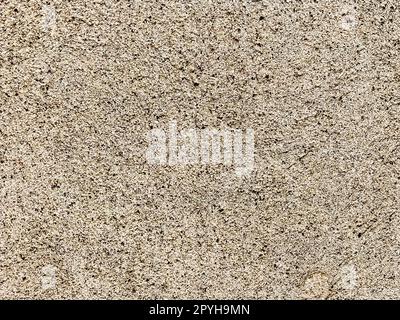 Concrete surface with multi-colored blotches of small stones. Light ...