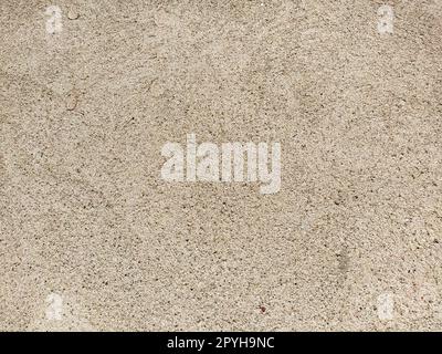 Concrete surface with multi-colored blotches of small stones. Light ...