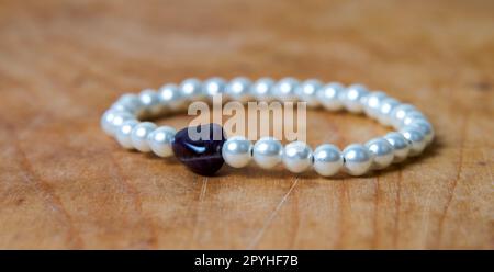 Bead bracelet on the wooden table Stock Photo - Alamy