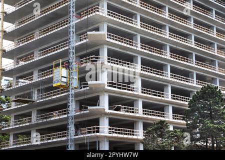 Tower with elevator near multistory building under construction Stock ...