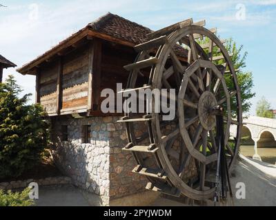 Wooden water mill. A hydraulic structure using hydropower from a water ...