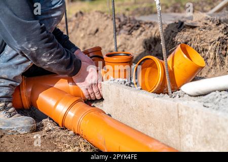 installation of a sewage plastic pipe during the construction of a ...