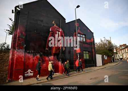 Liverpool fans walk past a mural of Liverpool captain Virgil van Dijk ...