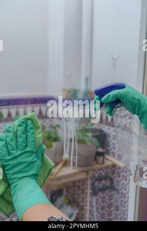 Female hands with rag washing window in room Stock Photo - Alamy