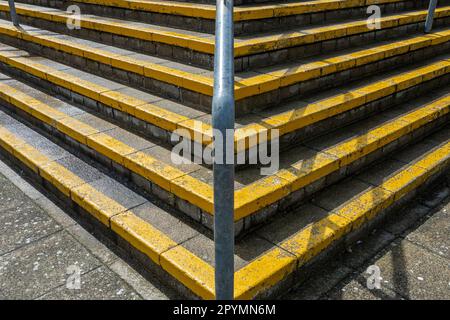Outdoor concrete steps with yellow safety markings and handrails Stock ...