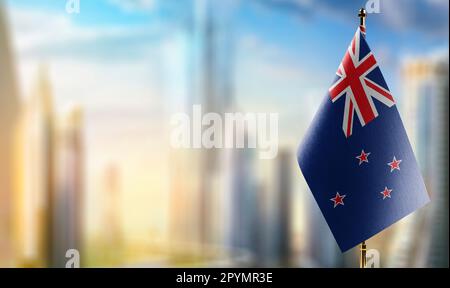 Small flags of the New Zealand on an abstract blurry background Stock ...