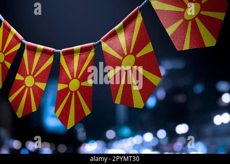 A garland of Macedonia national flags on an abstract blurred background ...