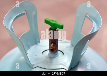A Freon gas cylinder filled with colorless gas at room temperature ...