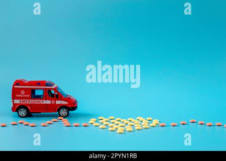 Drawing of a cardiogram from pills on a blue background and ambulance ...