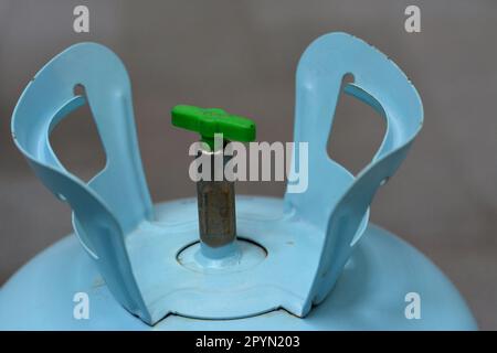 A Freon gas cylinder filled with colorless gas at room temperature ...