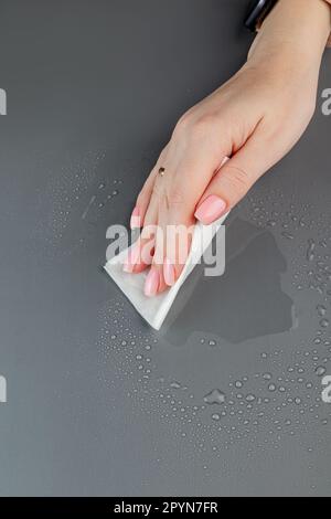 Closeup of woman's hand wiping table with rag at home Stock Photo - Alamy