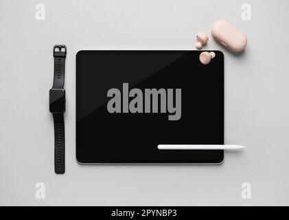 Tablet, stylus, smartwatch, headphones Stock Photo - Alamy