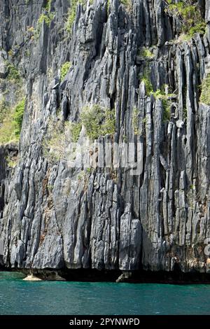 massive limestone rocks in the blue sea at the el nido archipelago ...