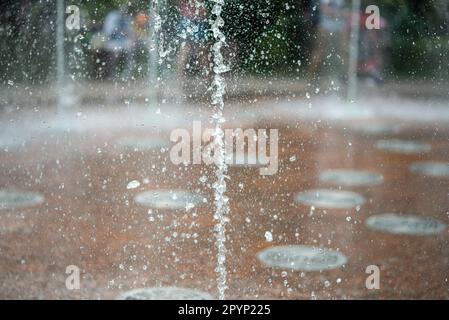 Fountain water jets rising from marble tiles Stock Photo - Alamy