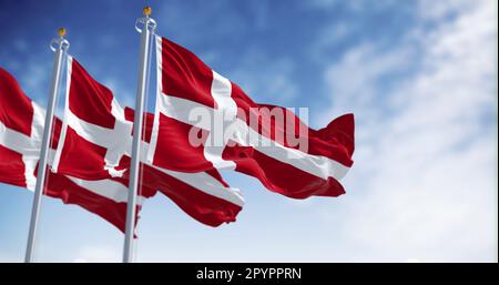 Three Denmark national flags waving in the wind on a clear day Stock ...