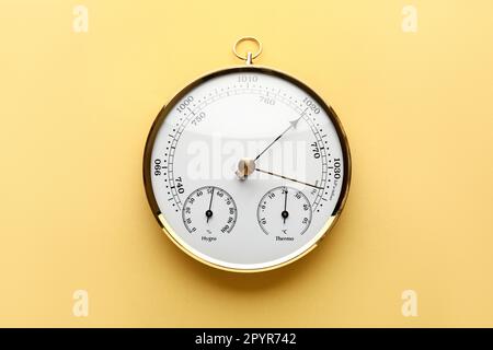 Aneroid barometer on yellow background Stock Photo - Alamy