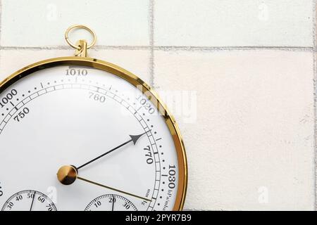 Aneroid barometer on white tiled background Stock Photo - Alamy