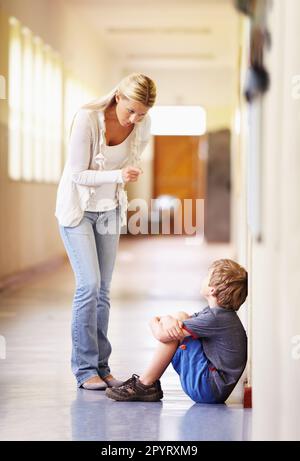Teacher woman scolding student boy in modern classroom interior Stock ...