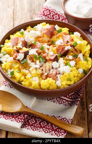 Traditional Ukrainian dish Banosh. Corn porridge in butter sprinkled on ...