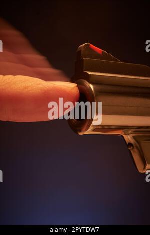 Finger blocking the barrel and the firing of a pistol Stock Photo - Alamy