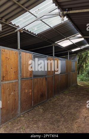 Empty boxes for horses in a rural area of Italy Stock Photo - Alamy