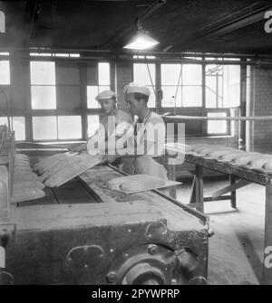 Employees of the industrial bakery Wittler Brot preparing dough. After ...