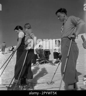 A cameraman sets his camera. Actors and extras are waiting for their ...
