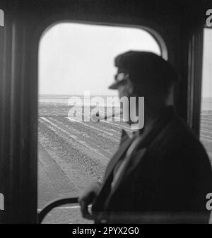 Adolf Hitler looks out the window of a train railway carriage during a ...