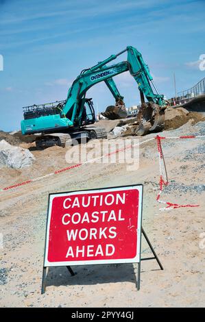 Earth movers working on Cleveleys beach and seawall Stock Photo - Alamy