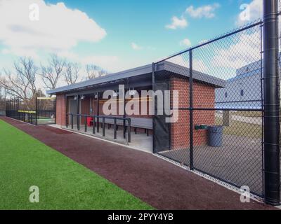 Brick baseball dugout with concrete floor, benches and protective ...