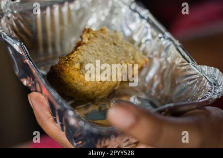 Chhena poda or baked cheese served on a shaal leaf. Chena pora is a ...